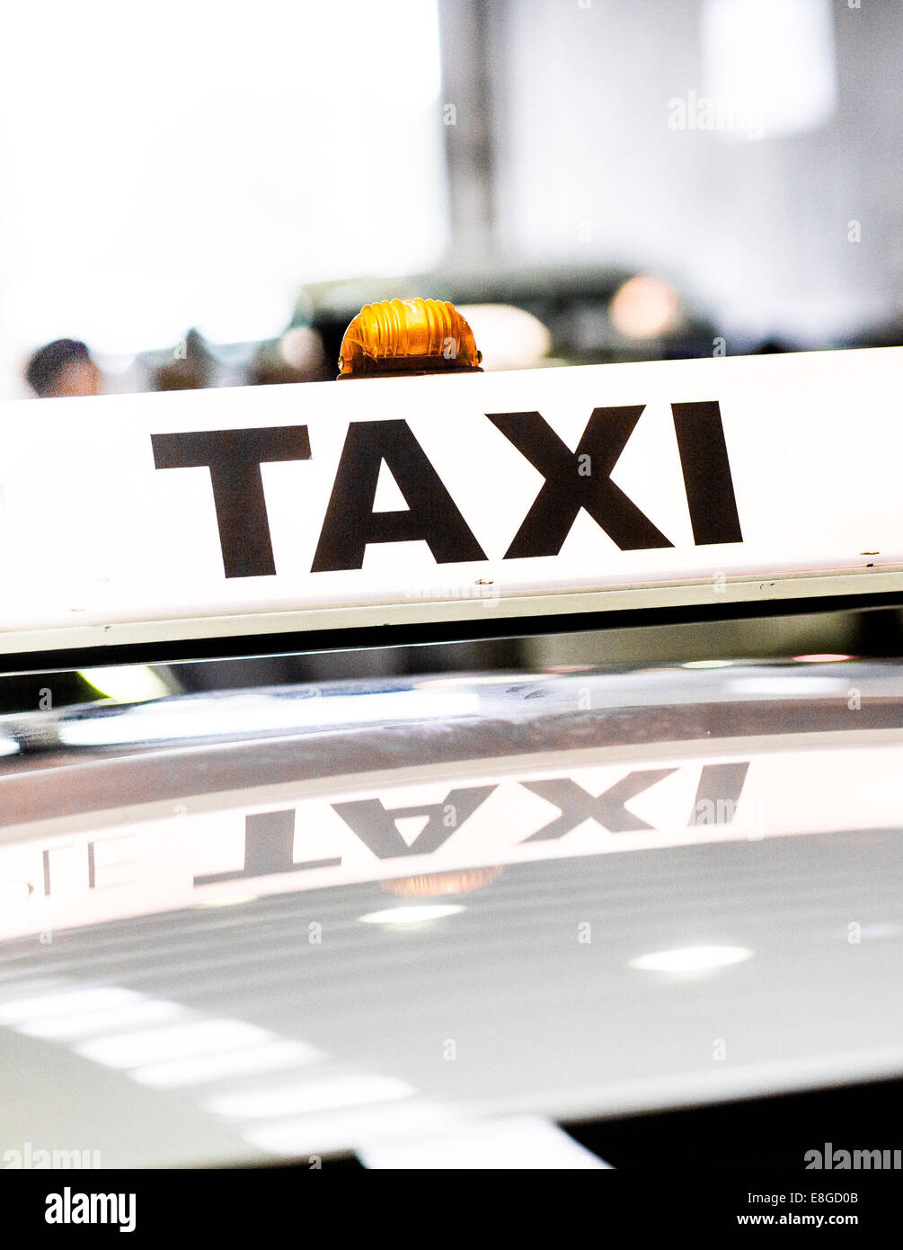 A taxi sign on top of a taxi photographed on a bright day Stock Photo ...