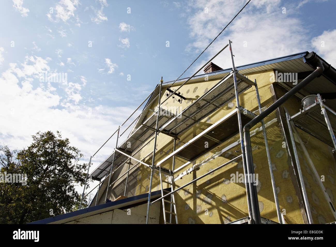 old brick wall house thermal insulation with mineral rockwool over blue ...