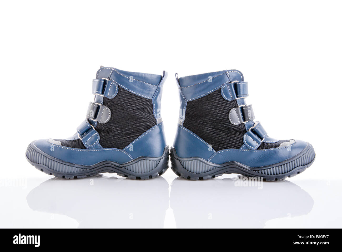 New children pair of winter boots with protector and reflection on ...