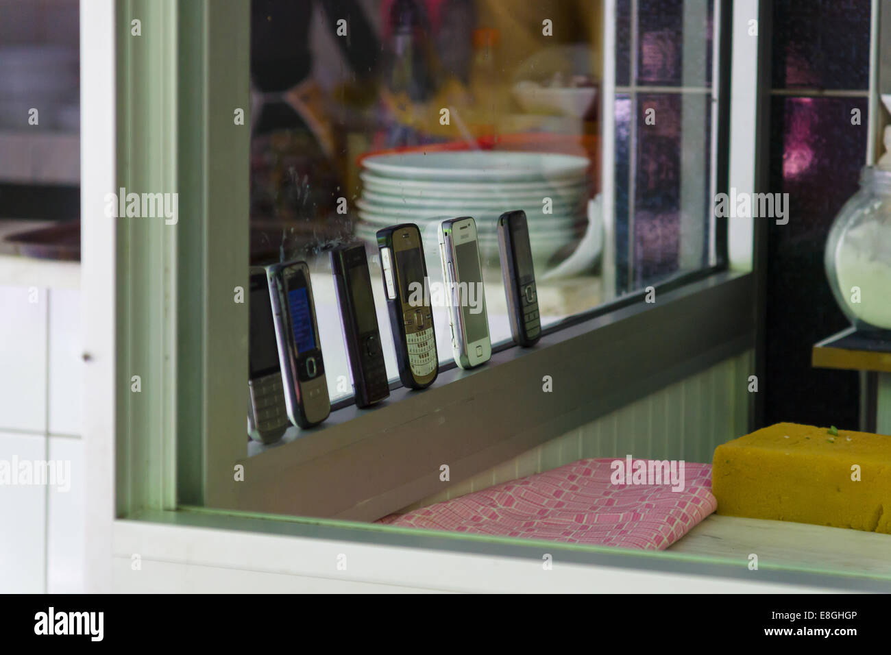 Mobile phones are near a window in a row Stock Photo - Alamy