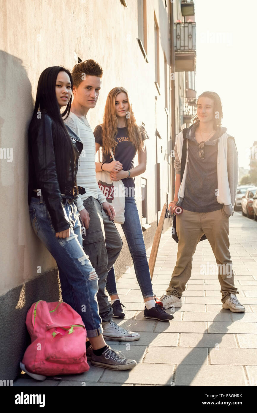 Full length portrait of high school students standing on sidewalk Stock ...