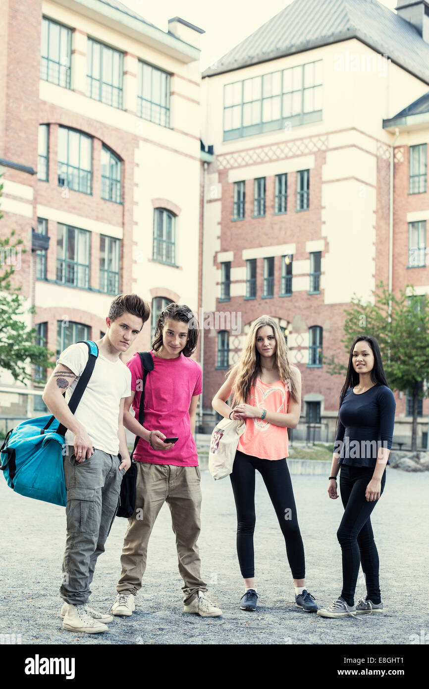 Full length portrait of confident high school student standing on ...