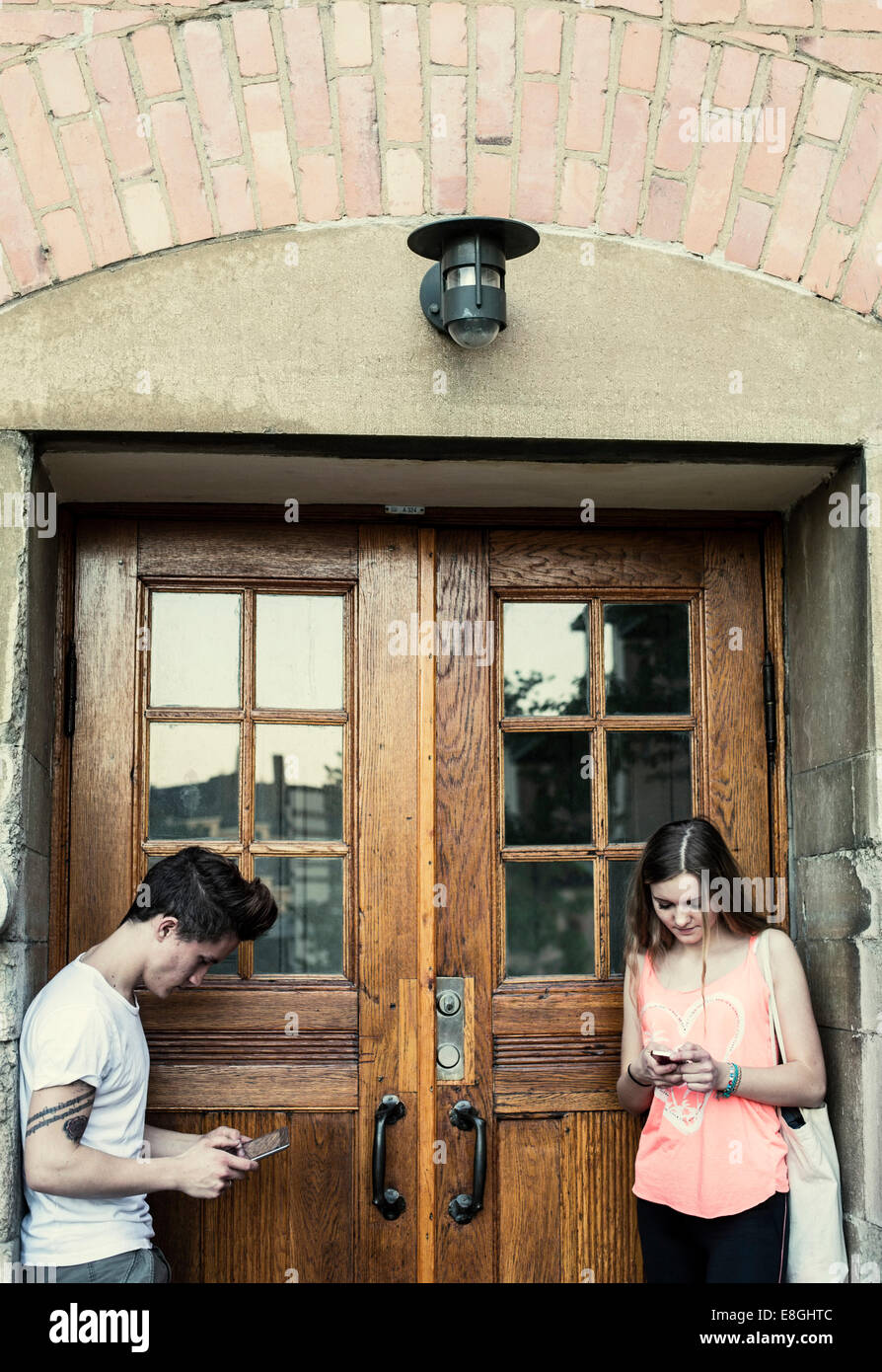 Students waiting outside entrance of high school building Stock Photo ...