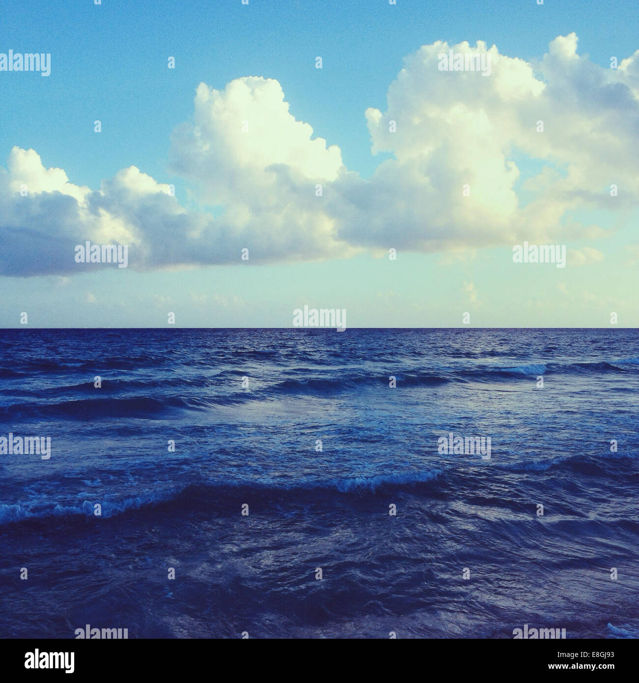 Blue sea with blue sky and white clouds Stock Photo - Alamy