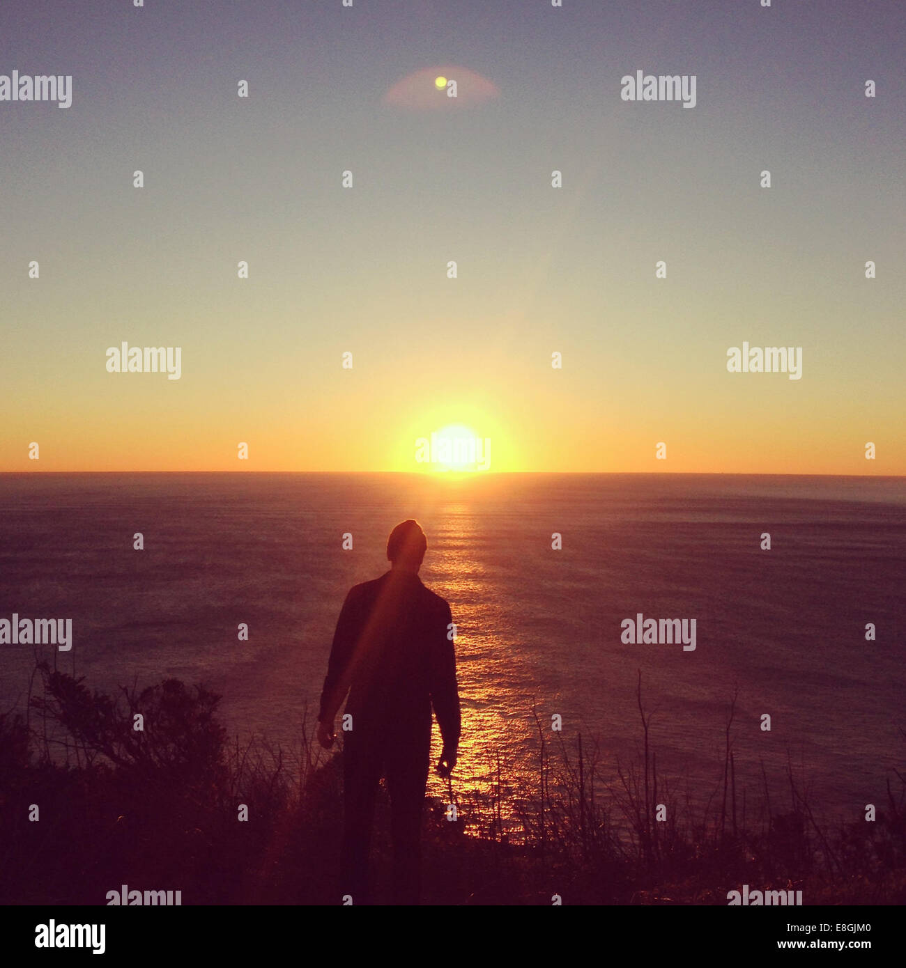 Silhouette of man looking at sunset hi-res stock photography and images ...