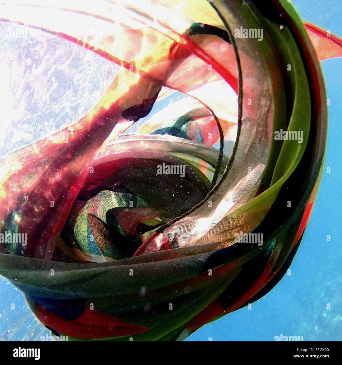 Multi-colored scarf floating underwater Stock Photo - Alamy