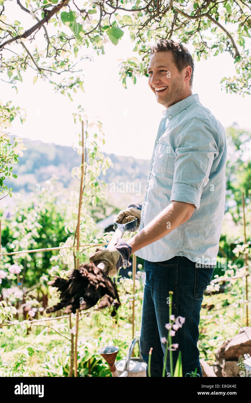 Happy man gardening at yard Stock Photo - Alamy