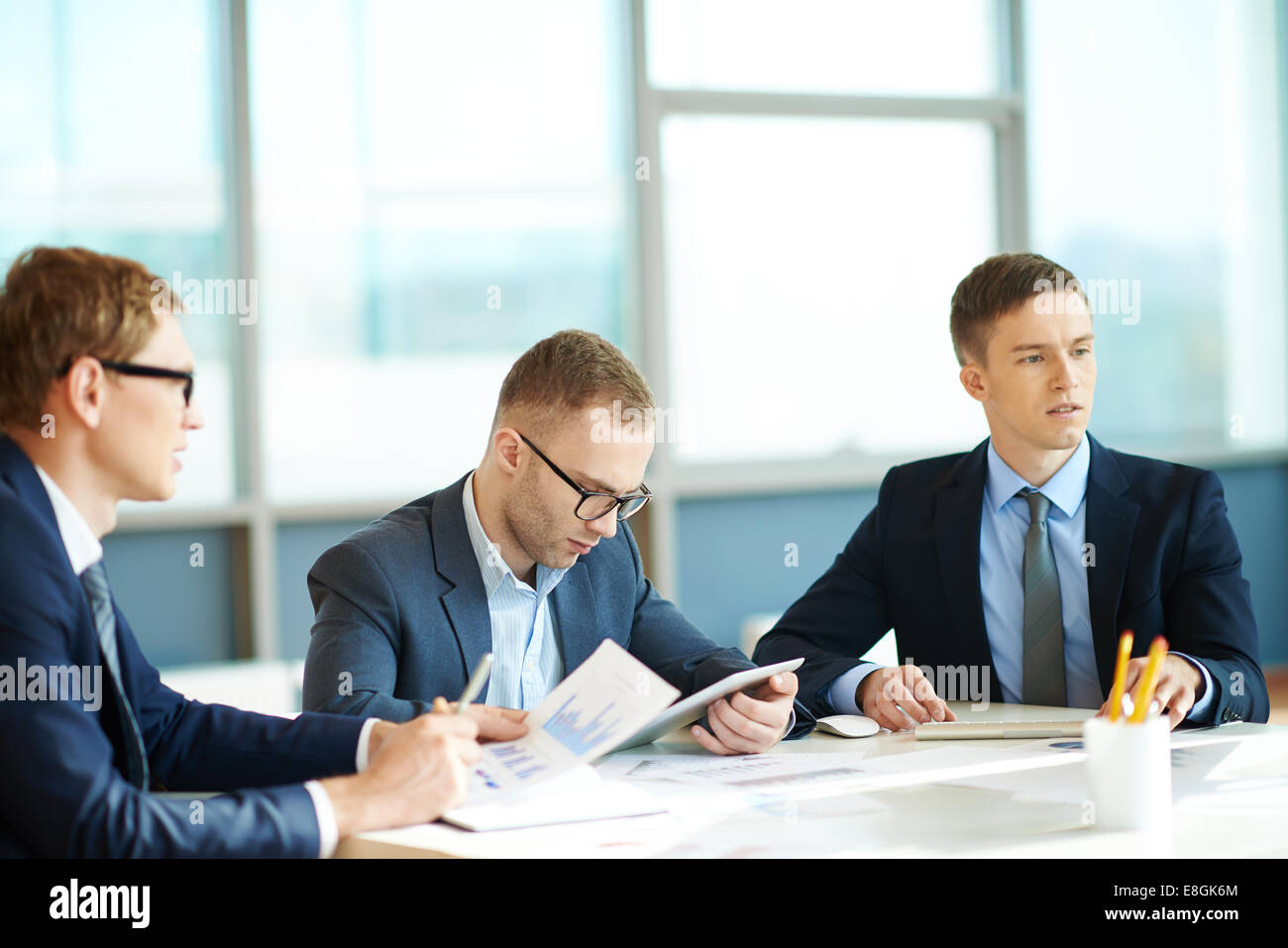Three men at meeting in office Stock Photo - Alamy