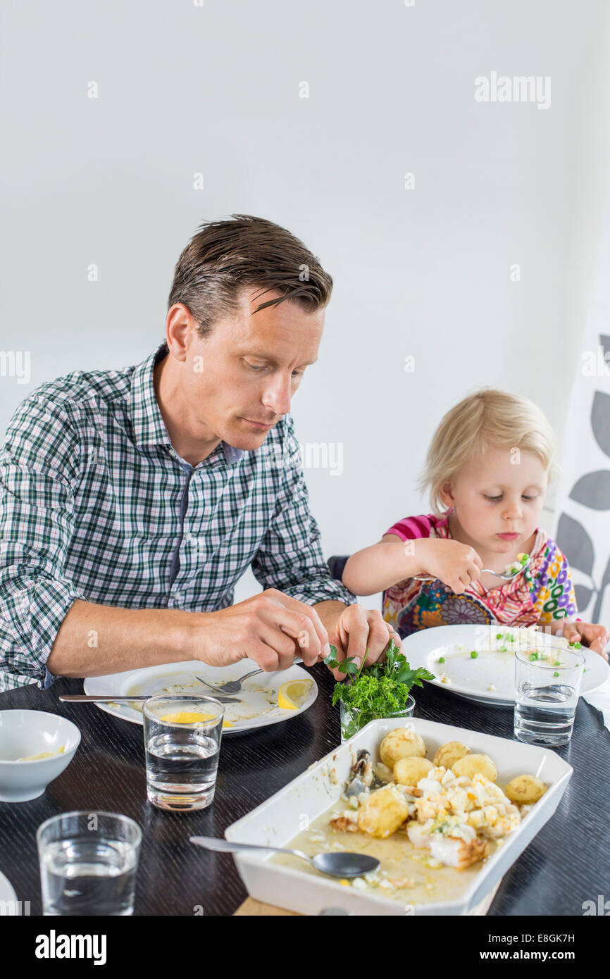 Father and daughter having lunch at home Stock Photo - Alamy