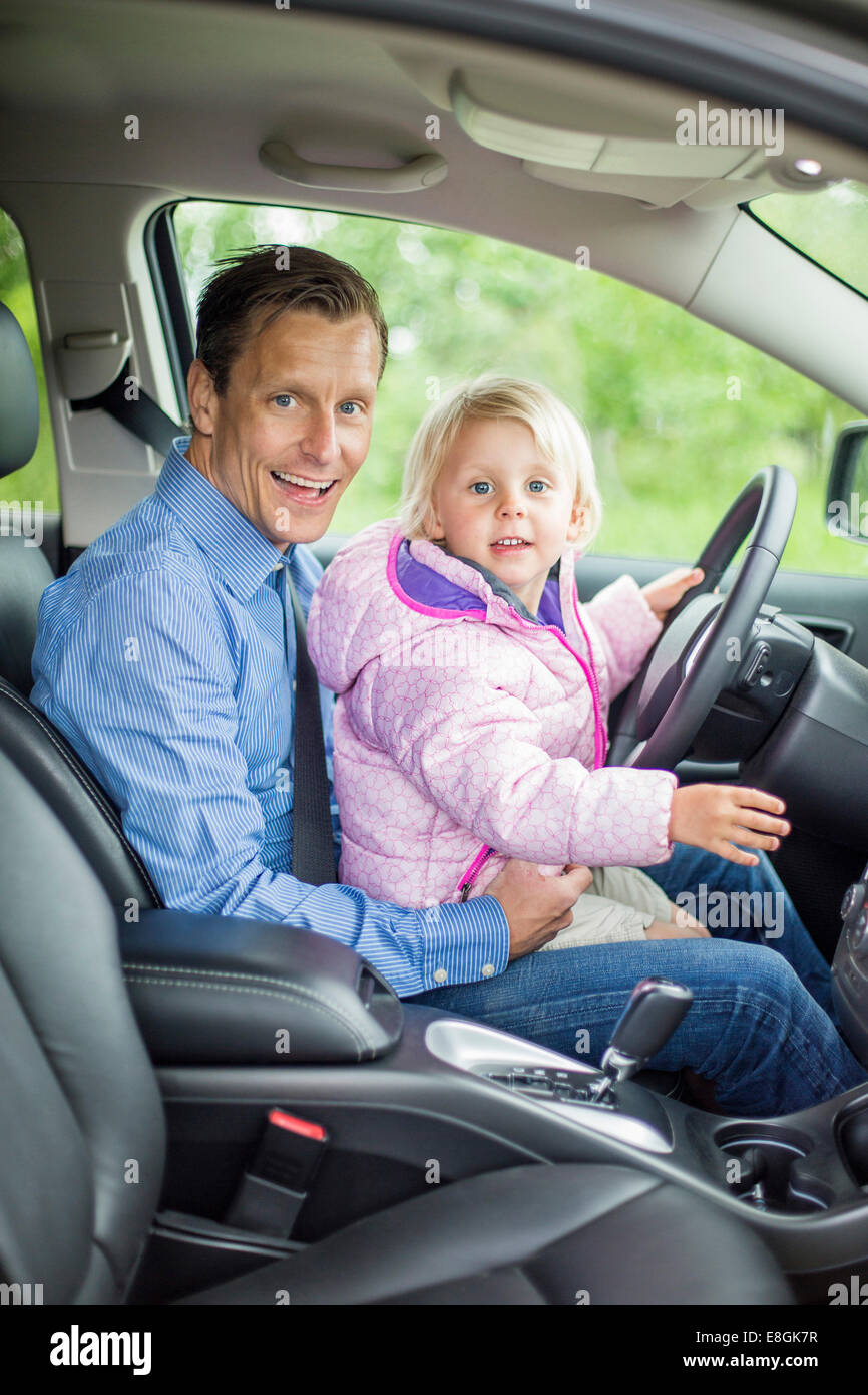 Portrait of happy father and daughter in car Stock Photo - Alamy