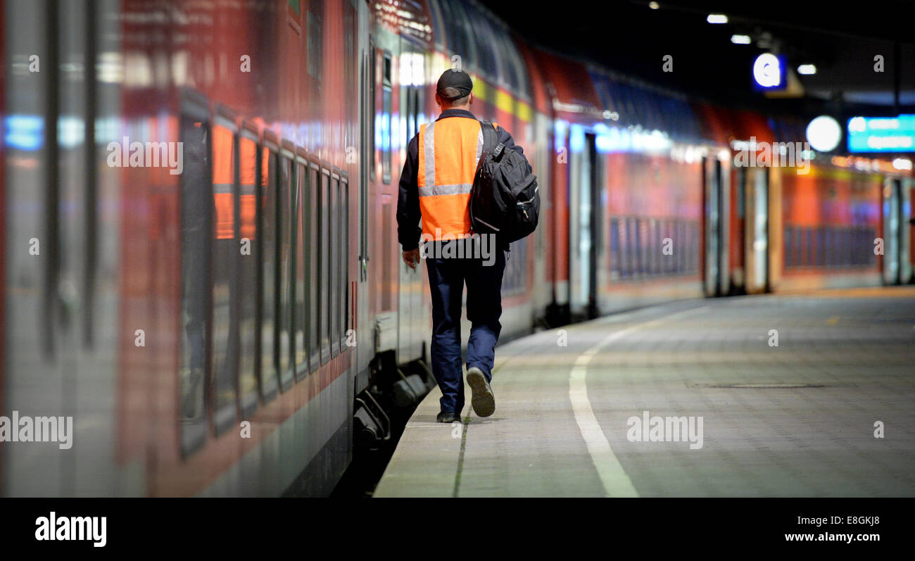 An Engine-driver walks along his train at the central train station in ...