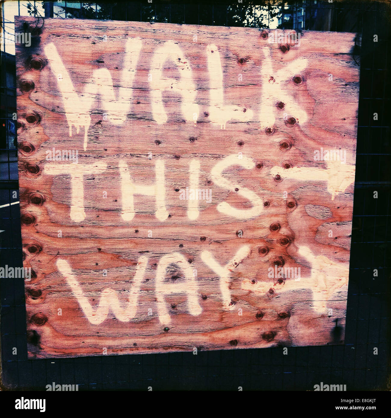 Walk this way Direction sign on sidewalk near construction site Stock ...