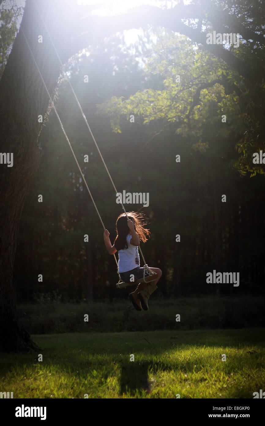 Girl swinging on a rope swing in the garden, Mississippi, USA Stock ...