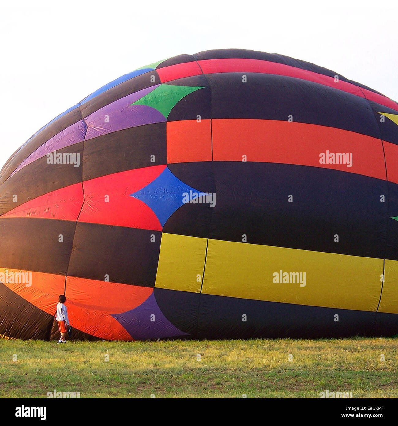 Boy looking at hot air balloon Stock Photo - Alamy