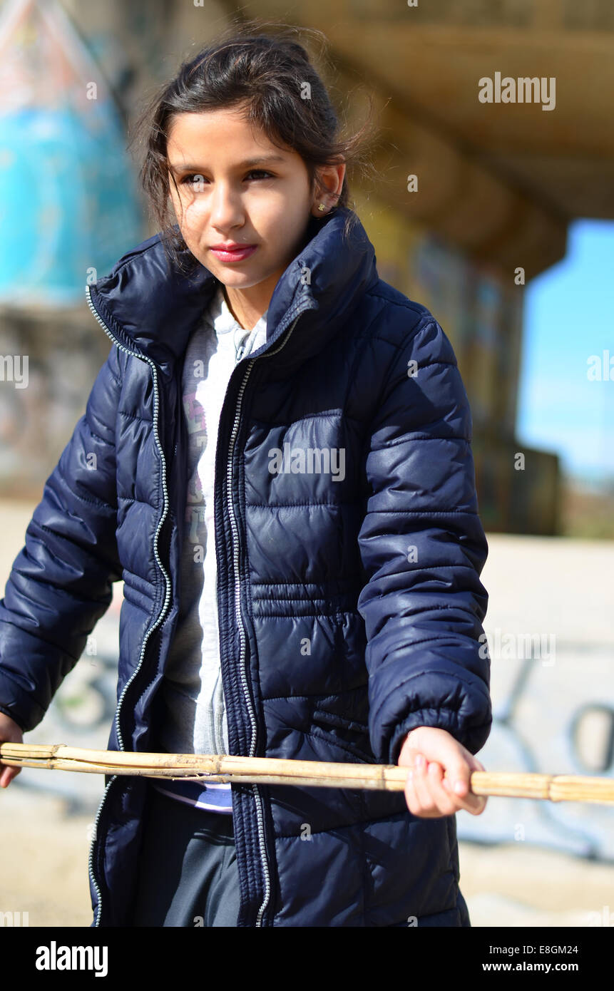 Girl holding a stick Stock Photo - Alamy
