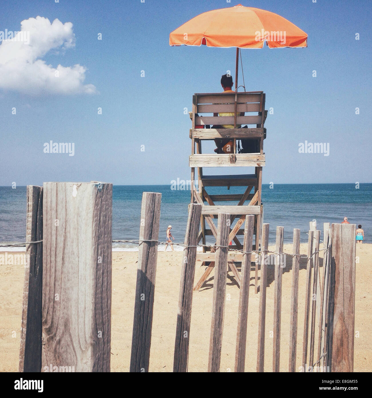 Lifeguard sitting on beach Stock Photo - Alamy