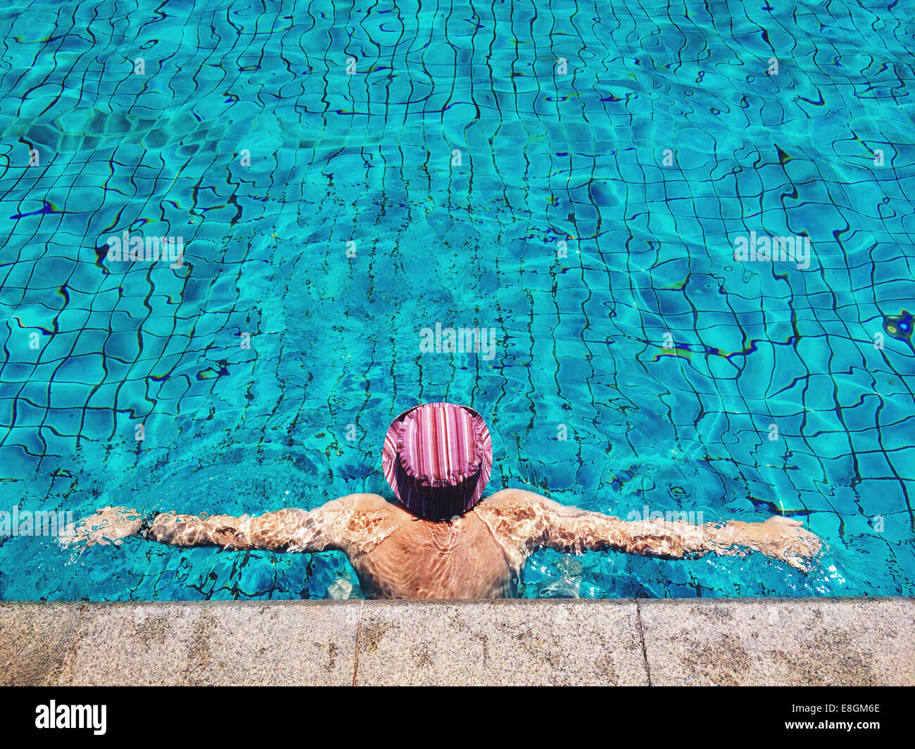Rear view of man in swimming pool, Thailand Stock Photo - Alamy