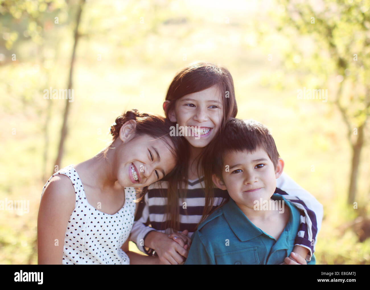 Portrait of three children smiling Stock Photo - Alamy
