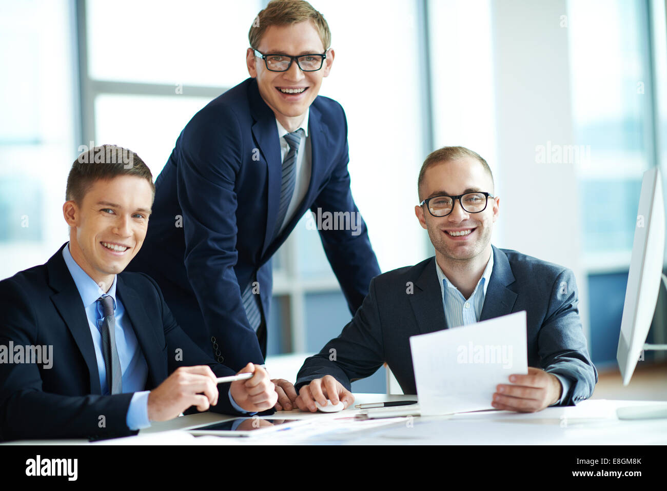 Three businessmen smiling at camera Stock Photo - Alamy