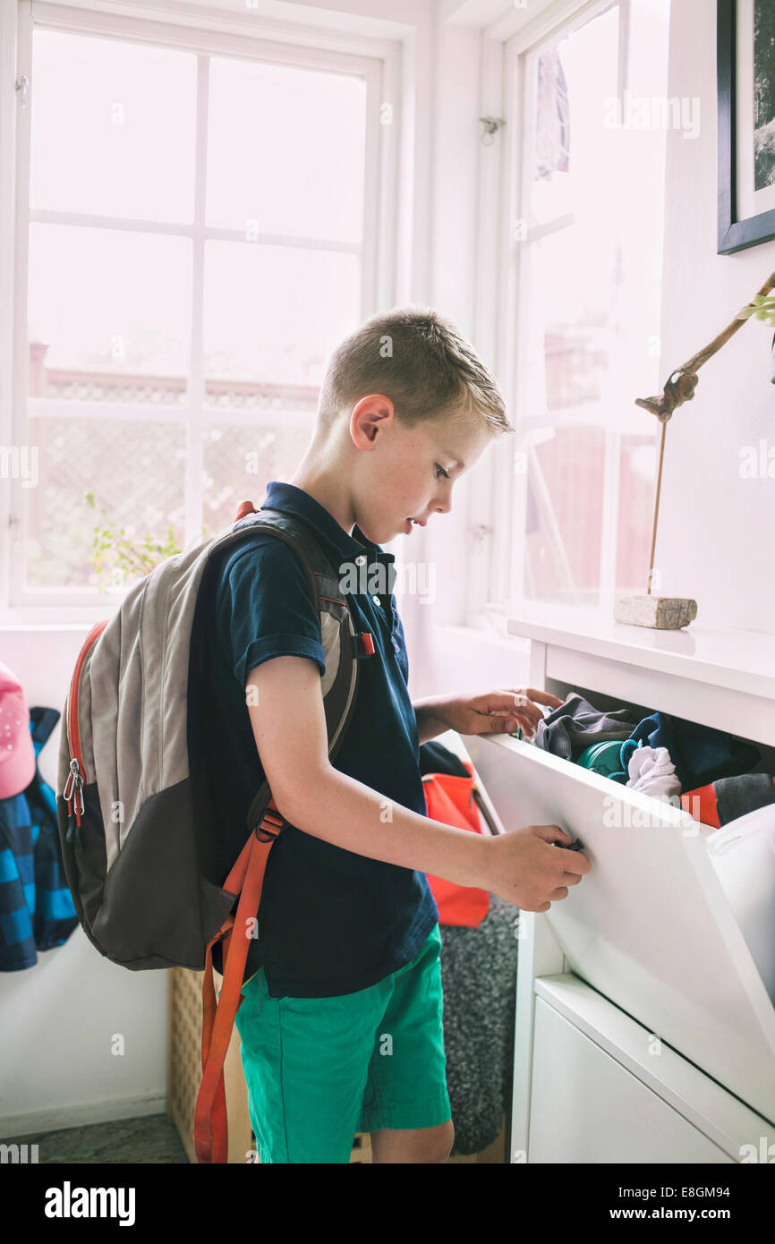 School boy searching for clothes in drawer at home Stock Photo - Alamy