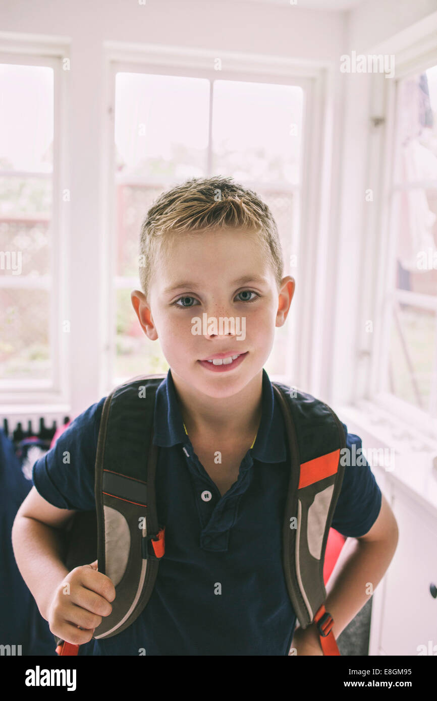 Portrait of boy carrying backpack at home Stock Photo - Alamy