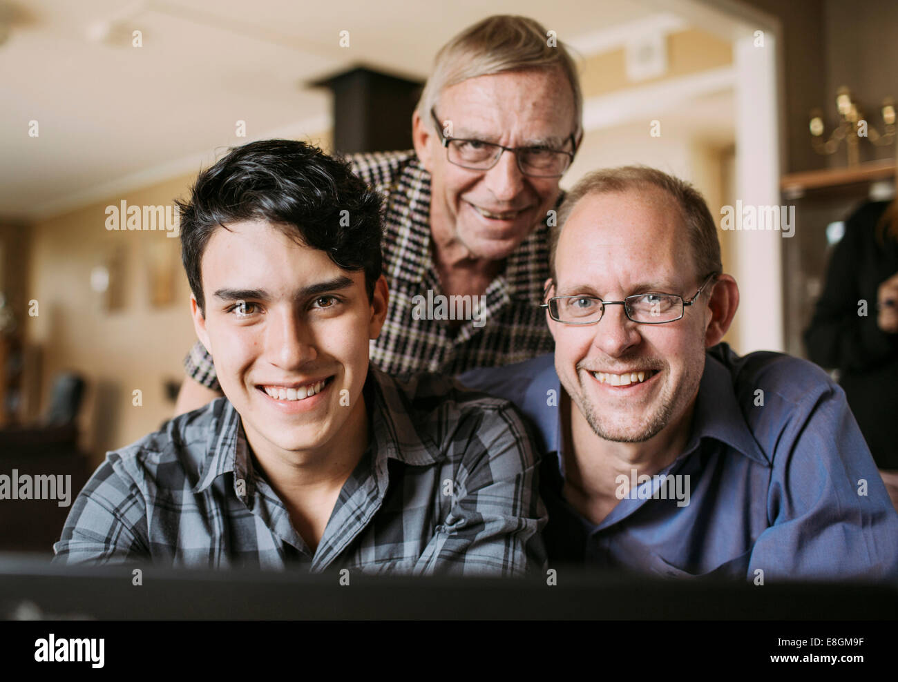 Portrait of three generation family smiling together at home Stock ...