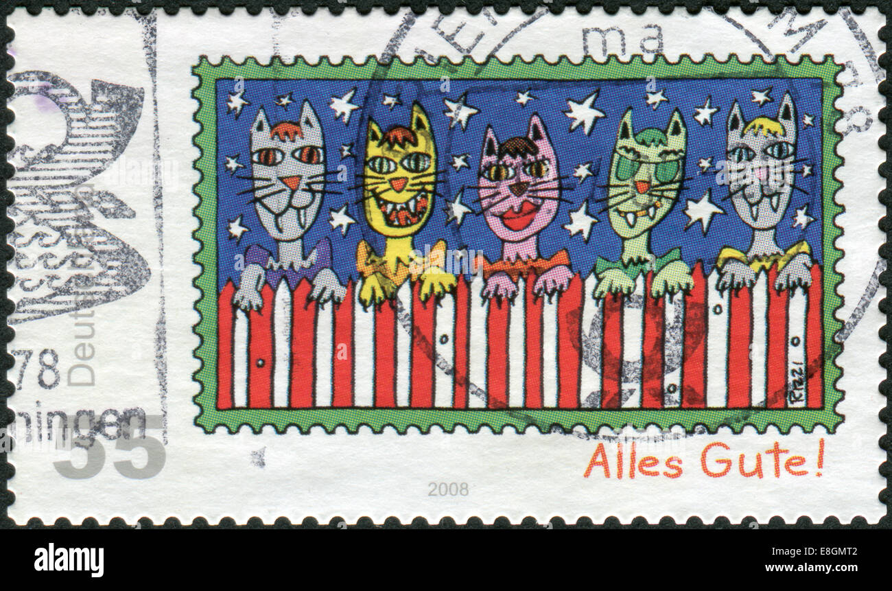 Postage stamp printed in Germany, Greeting stamps, depicts a happy cats ...