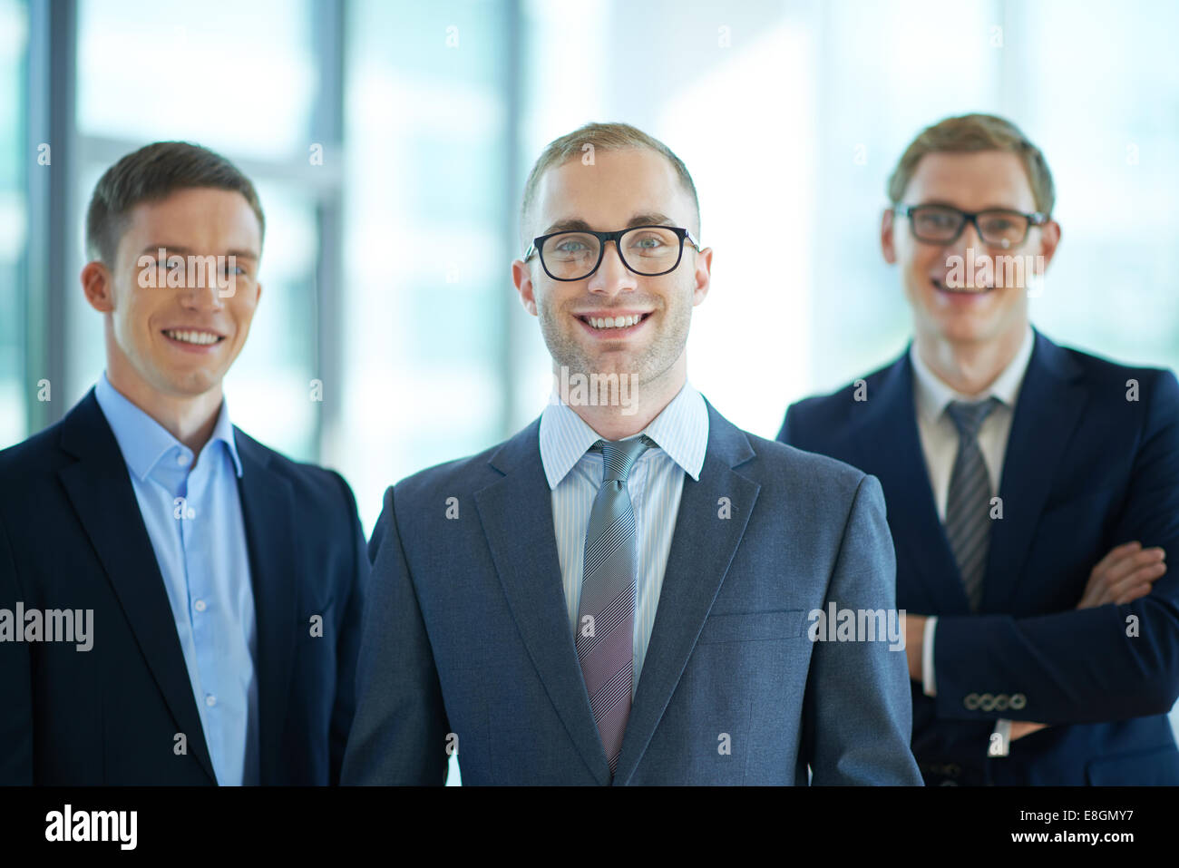 Team of three confident businessmen Stock Photo - Alamy