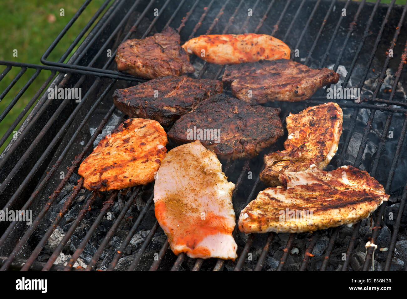 Heavily roasted meat on a charcoal grill Stock Photo - Alamy