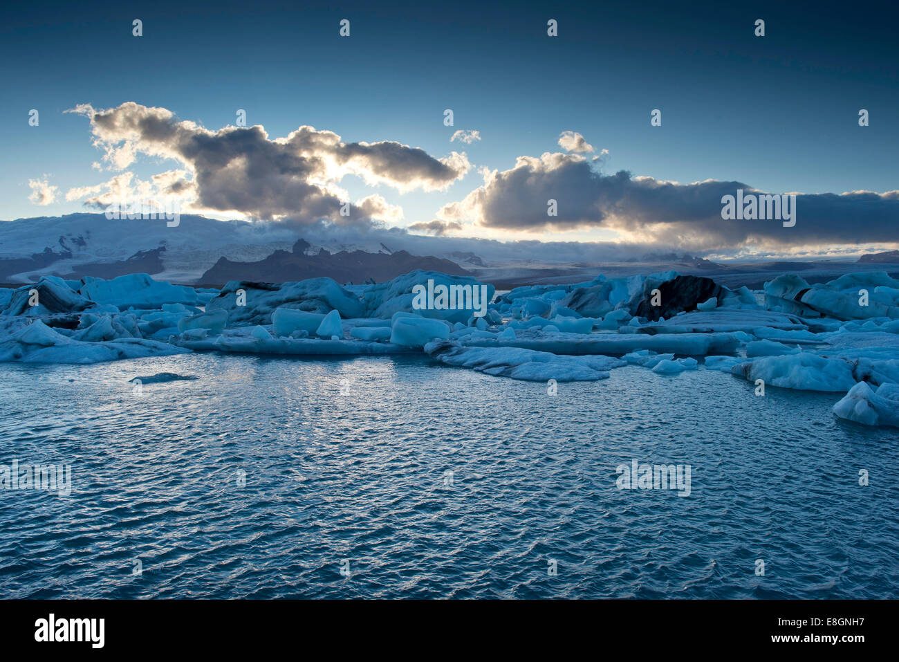 Evening mood, sun behind clouds, glacier lagoon of Jökulsárlón ...