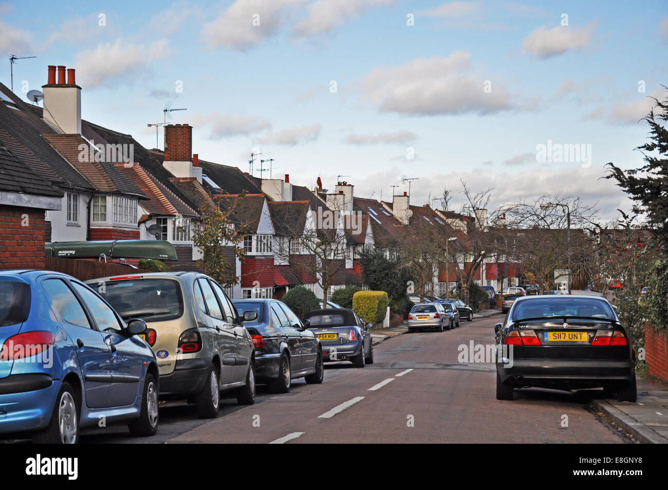 Suburban street of period houses and parked cars in London, England, UK ...
