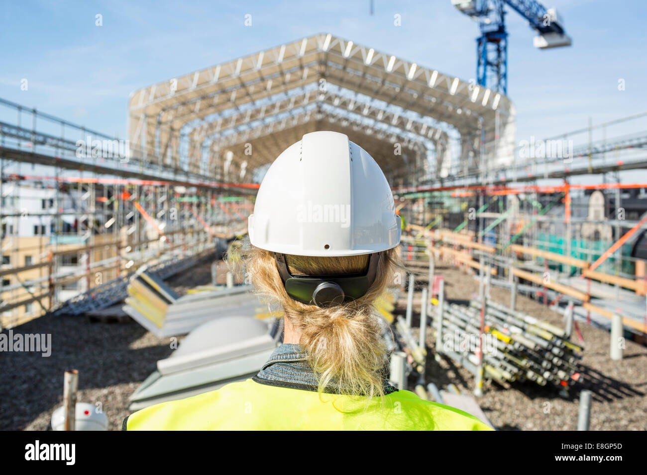 Rear view of female construction worker at site Stock Photo - Alamy