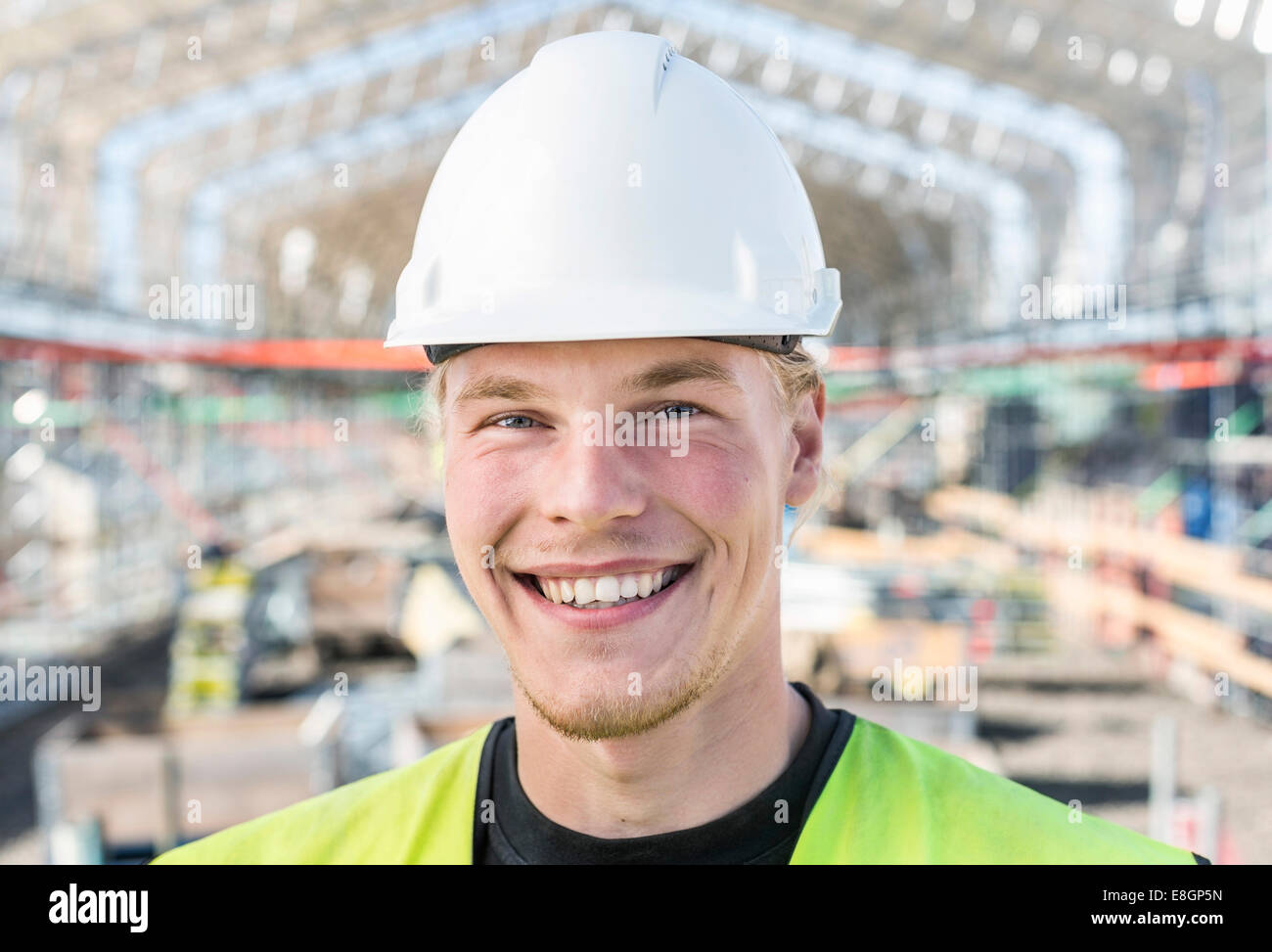 Portrait of happy worker at construction site Stock Photo - Alamy
