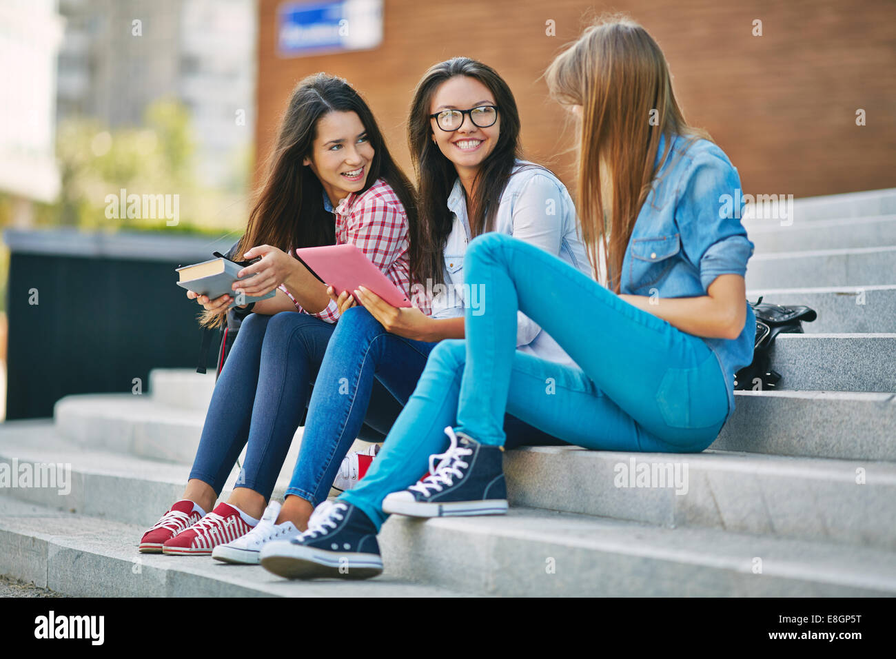 Three teenage girls communicating outdoors Stock Photo - Alamy