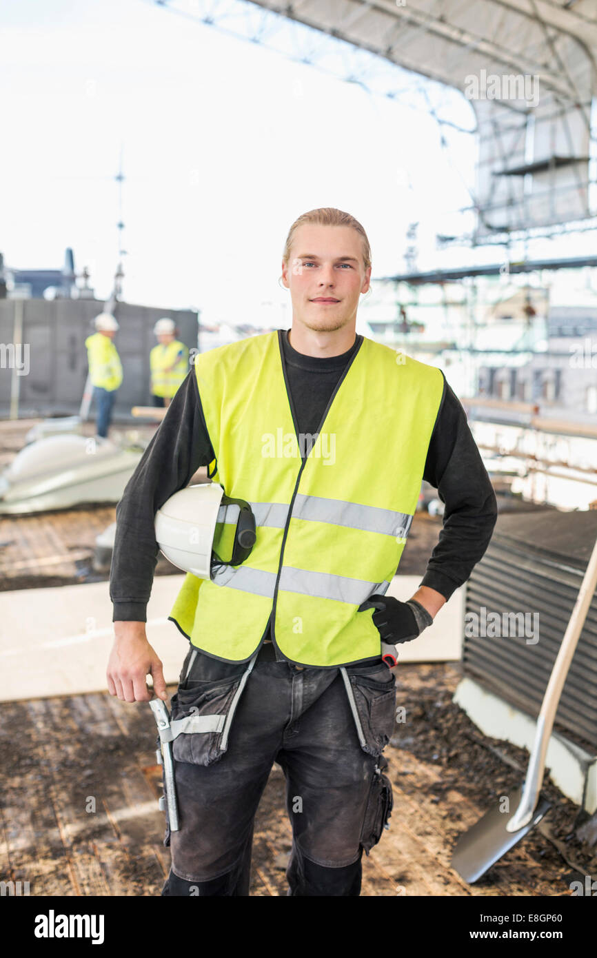 Portrait of confident construction worker standing at site Stock Photo ...