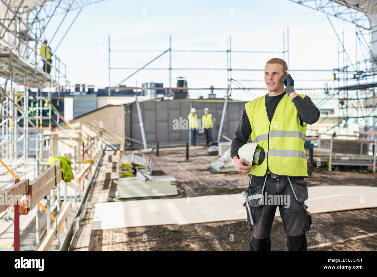 Worker using mobile phone at site Stock Photo - Alamy
