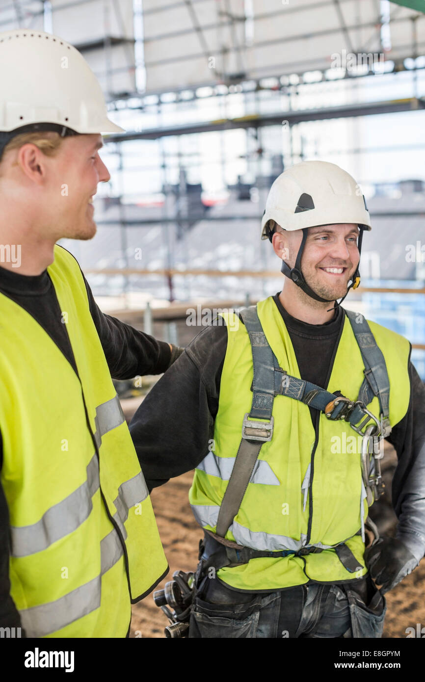 Smiling construction workers at site Stock Photo - Alamy