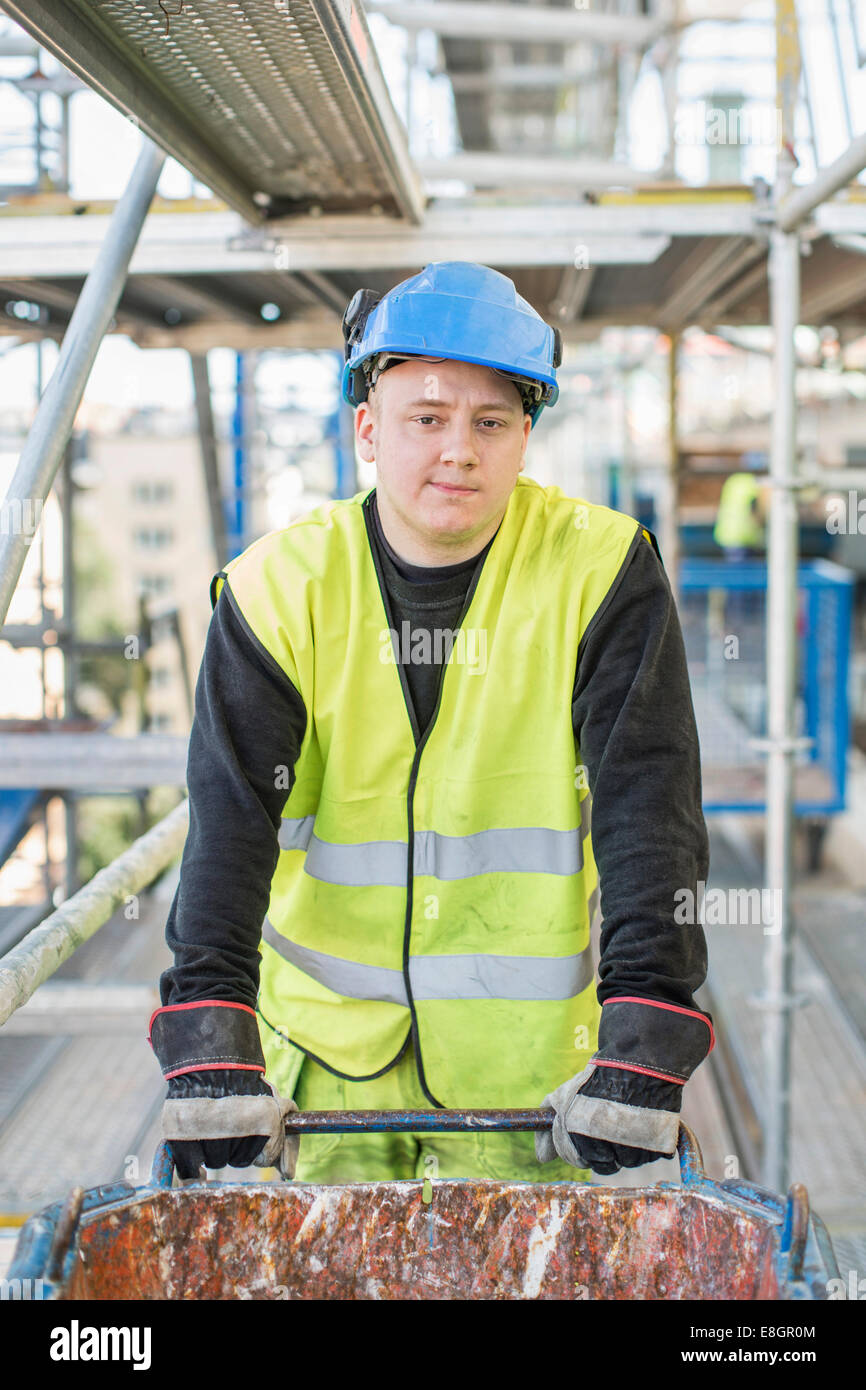 Portrait of confident construction worker standing at site Stock Photo ...