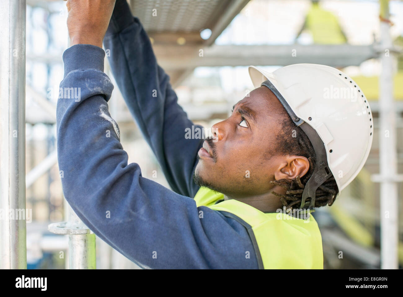 Side view of worker working at construction site Stock Photo - Alamy