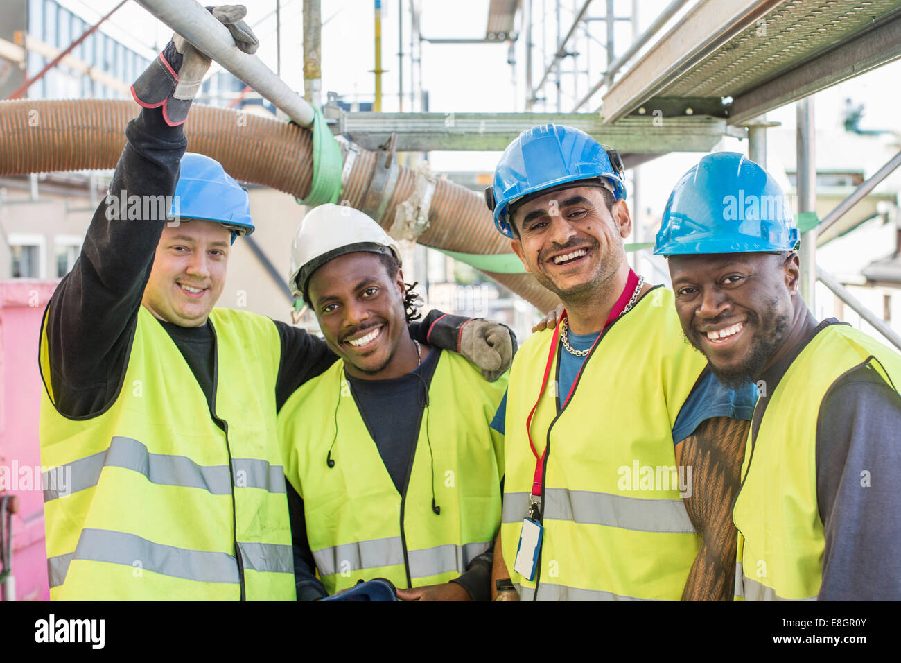 Portrait of happy construction workers standing together at site Stock ... Portrait of happy construction workers standing together at site Stock ...