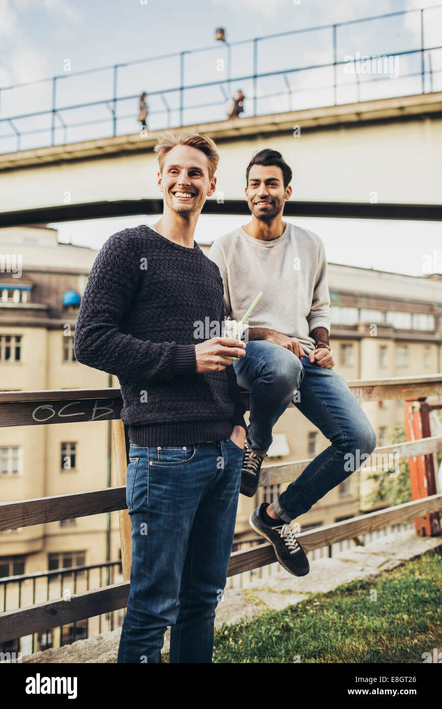 Happy male friends on roof garden Stock Photo - Alamy