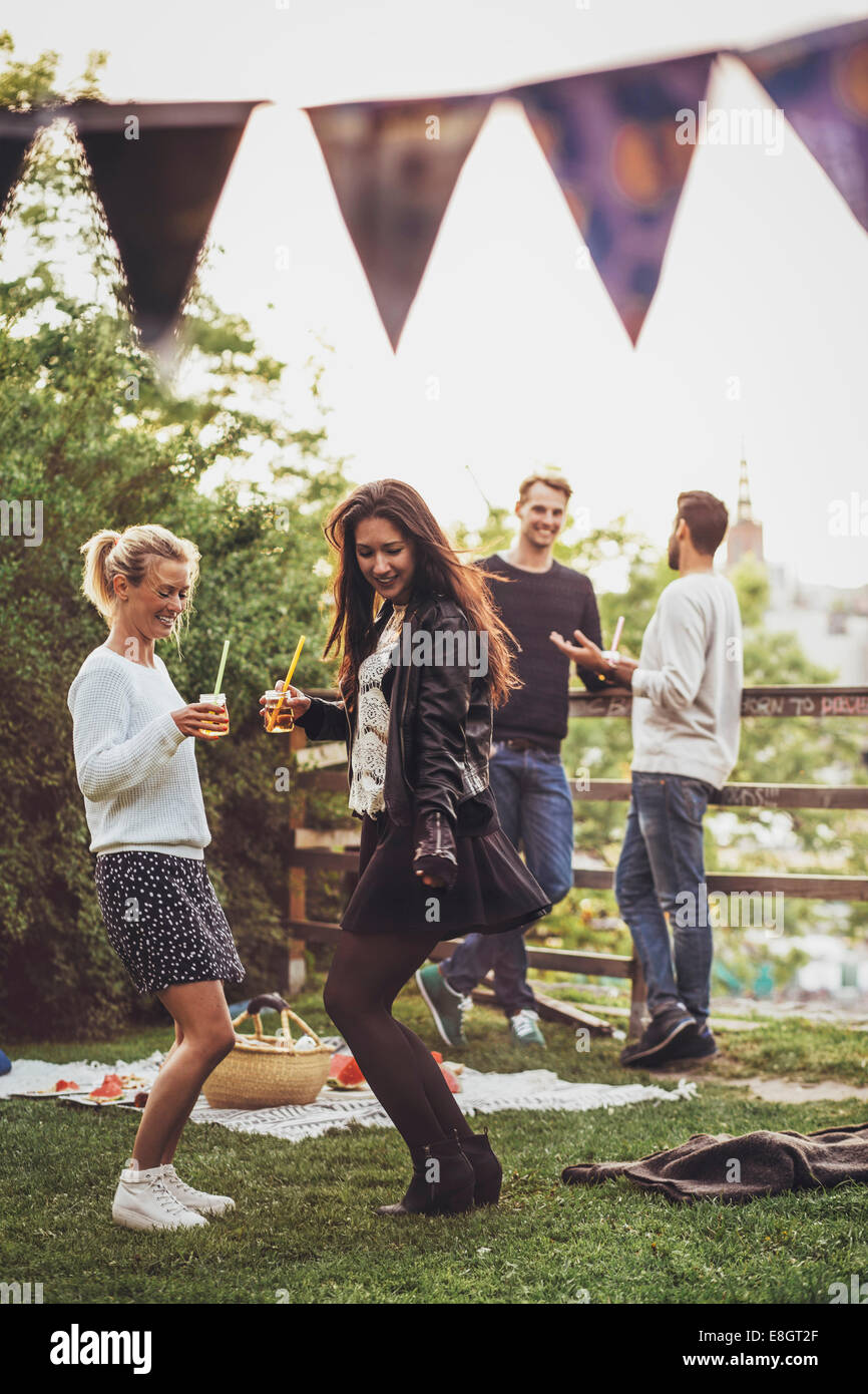 Female friends dancing at rooftop party Stock Photo - Alamy
