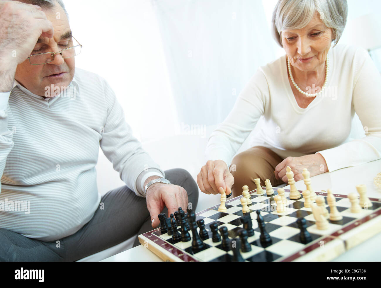 Senior couple playing chessboard hi-res stock photography and images ...