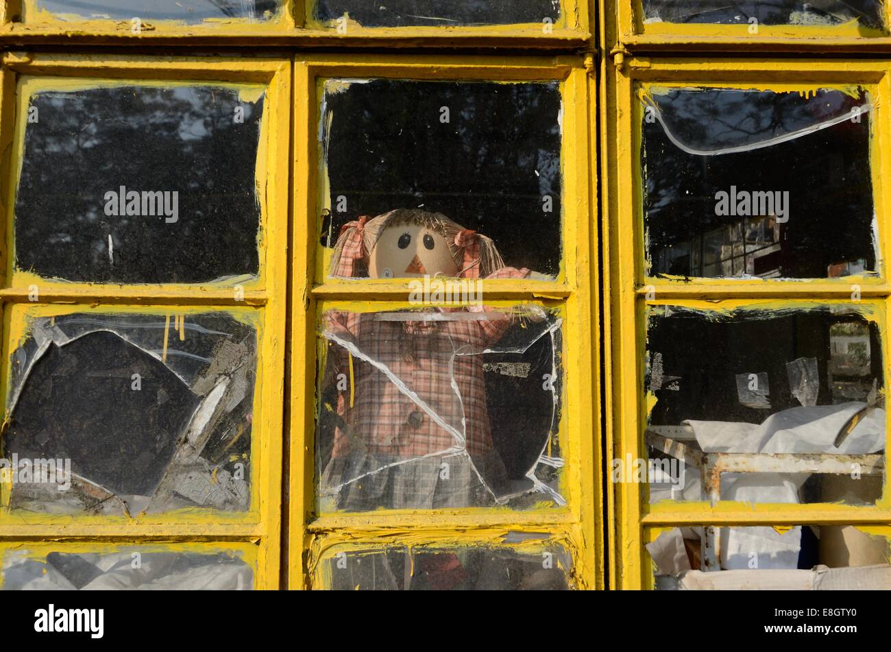 Doll in a window Stock Photo - Alamy