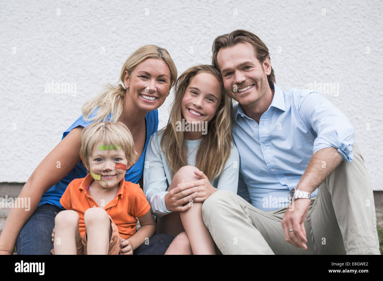 Portrait of happy two generation family sitting at yard Stock Photo - Alamy