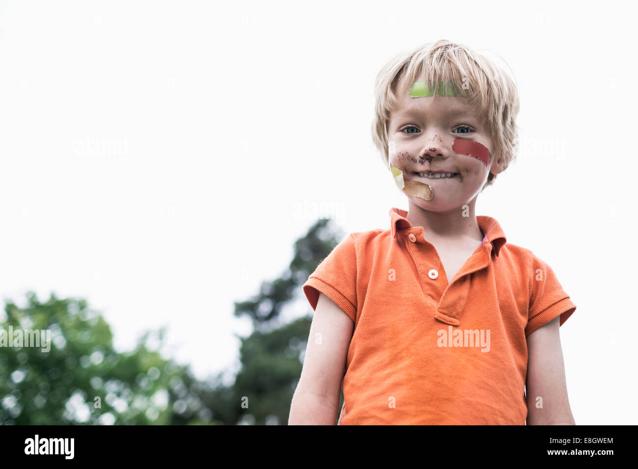 Portrait of injured boy standing against clear sky Stock Photo - Alamy