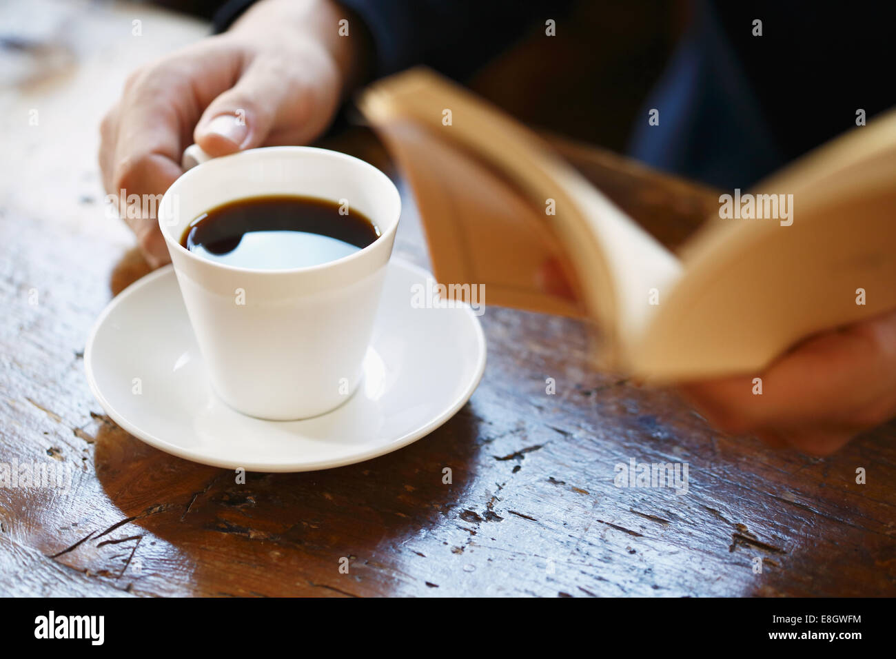Young Japanese Man Reading A Book In A Cafe Stock Photo - Alamy
