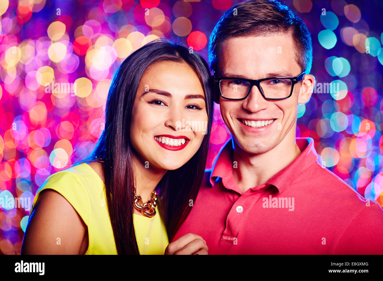 Portrait of two young people smiling at camera Stock Photo - Alamy