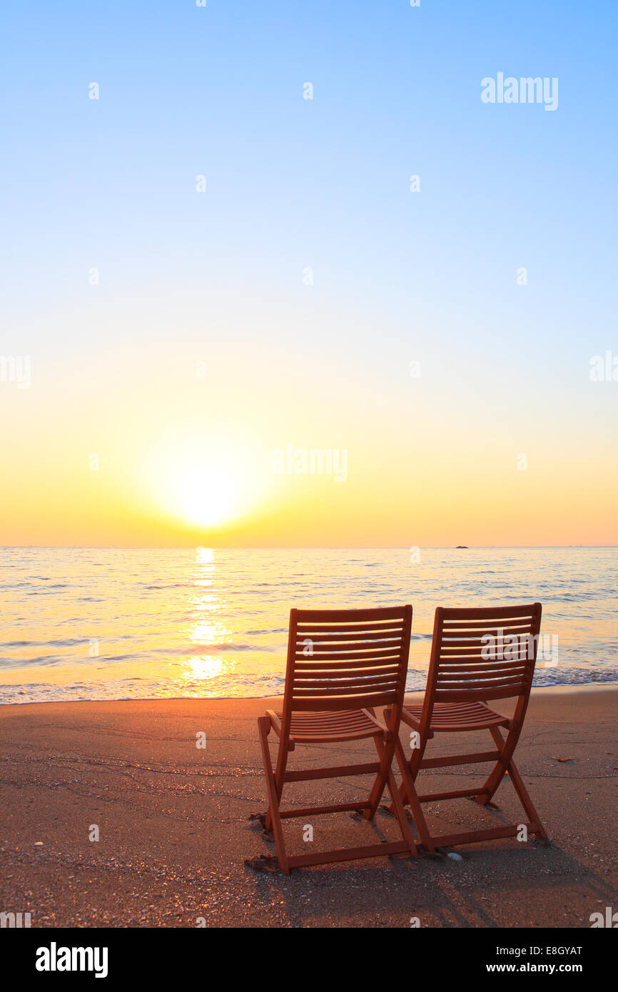 Chairs At The Beach At Sunset Stock Photo - Alamy