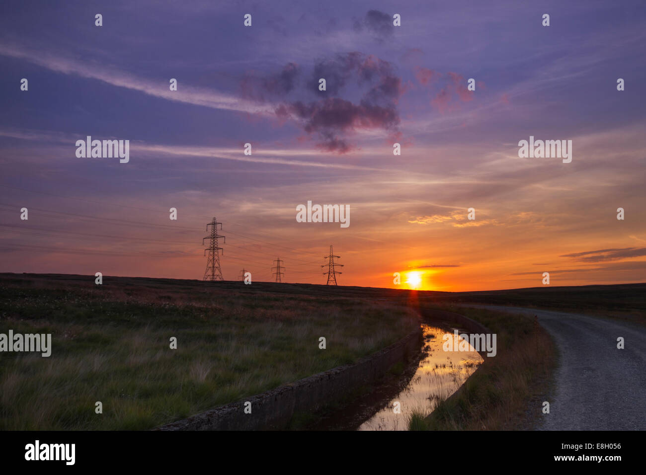 Sunset on the moors with pylons Stock Photo - Alamy